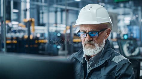 Car Factory Office Portrait Of Male Engineer Working On Computer