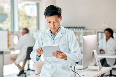 Science Man And Internet With Tablet In Laboratory To Monitor