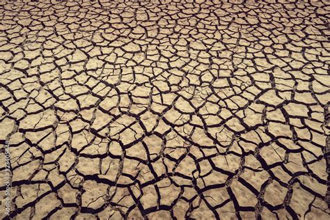Cracked Earth From Arid Drought Weather In Dam Or River Hot Summer