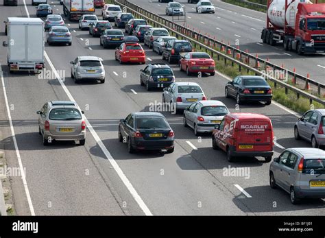 Variable Speed Limit Section Of The M42 Showing Traffic Using The Hard Shoulder In Attempt To