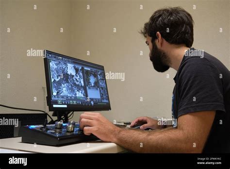Young Man Scientist Working With Scanning Electron Microscope Laboratory Technician Observing