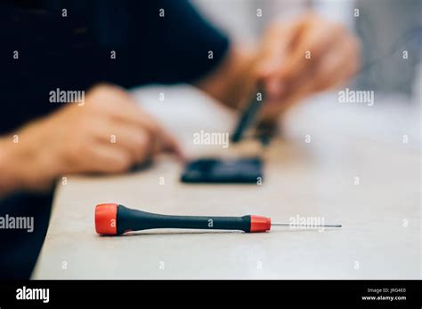 Technician Repair Faulty Mobile Phone In Electronic Smartphone Technology Service Cellphone