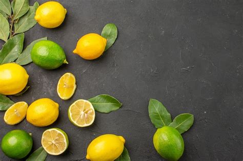 Free Photo Top View Fresh Lemons Sour Fruits On A Dark Table Citrus Lime Fruit