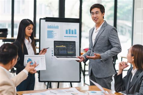 Professional Diverse Business Team Presenting And Discussing Data Charts And Graphs During