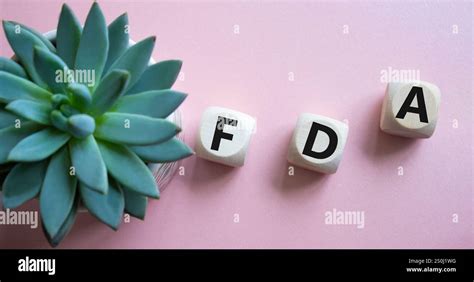 Fda Food Drug Administration Symbol Wooden Cubes With Word Fda Beautiful Pink Background