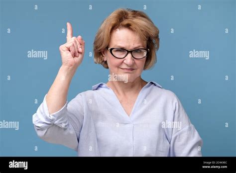 Mature Caucasian Woman Pointing Index Finger Up Giving Advice Stock