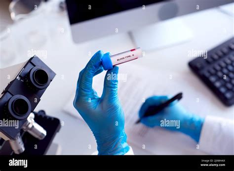 Close Up Of Lab Worker Conducting Research Using Microscope Holding