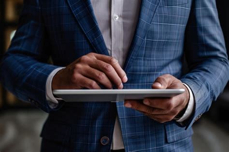 Premium Photo Man Holding Tablet In Suit