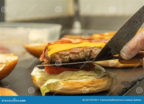 Chef S Hands Assembling Burgers With Cheddar Cheese And Bacon Over