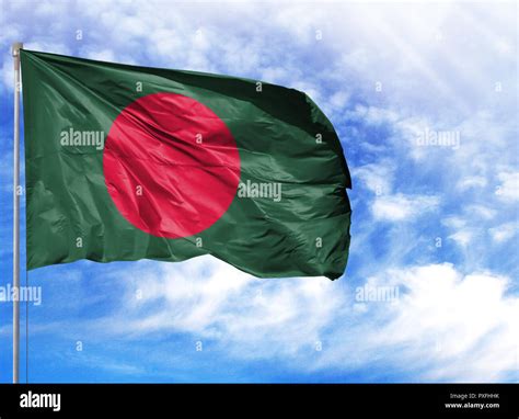 National Flag Of Bangladesh On A Flagpole In Front Of Blue Sky Stock