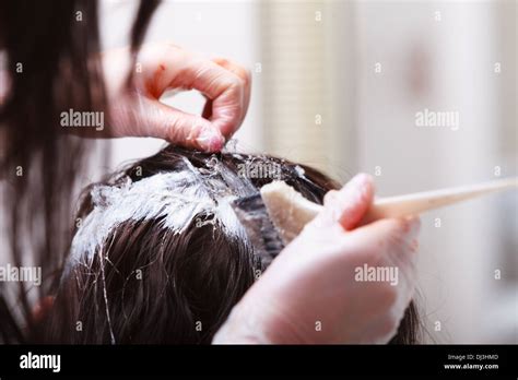 Hairdresser Applying Color To Female Customer At Hair Salon Woman Having Her Hair Dyed Stock