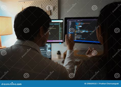 male and female web developers working with coded data on computer