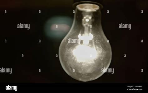 switching on turning off light bulb on white wall background footage