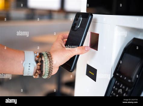 Girl Uses Smartphone To Scan Qr Code At Self Service Terminal Stock