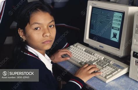 Peru Lima School Girl Learning Computer Sitting In Class Looking Towards Camera Superstock