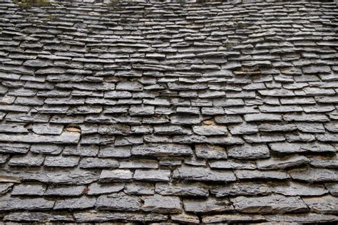 Premium Photo Traditional Slate Tiles On The Roof Of An Old Building