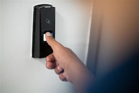 Man Pressing Fingerprint Scanner On Alarm System Indoorsfinger Print