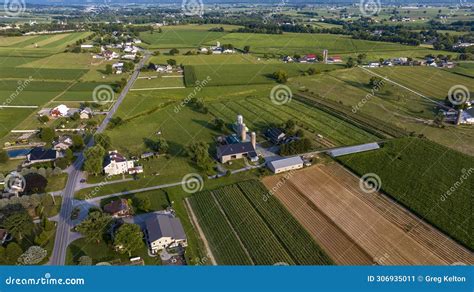 high angle view of rural community with farms crops in neat rows