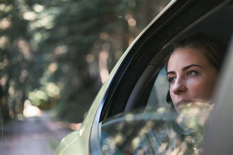 Woman Looking In The Forest From Car By Stocksy Contributor Pardina
