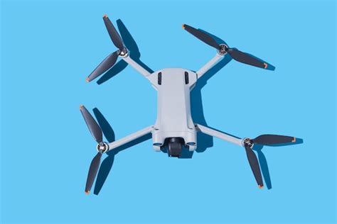Premium Photo Gray Drone With Photo And Video Camera And Dark Propellers On A Blue Background
