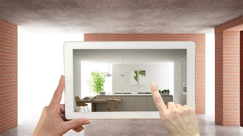 증강 현실 개념 인테리어 건설 현장에서 가구 및 디자인 제품을 시뮬레이션하는 데 사용되는 Ar 응용 프로그램과 손 잡고 태블릿 섬현대 흰색 부엌 가구에 대한 스톡 사진 및