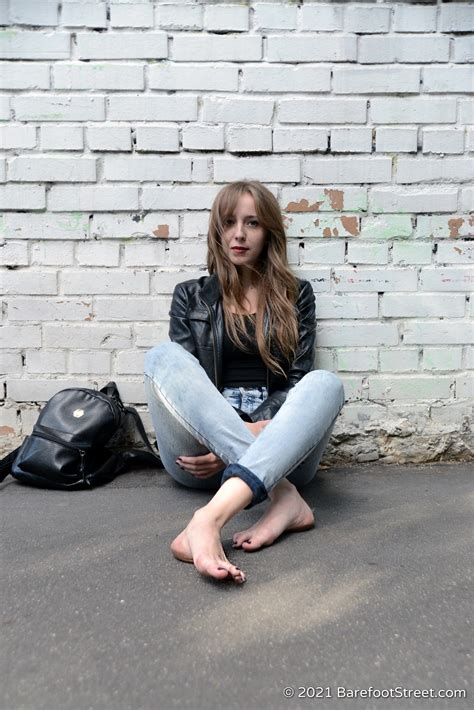 Young Beautiful Singer Anna Walks Barefoot Along The Sunny City Streets