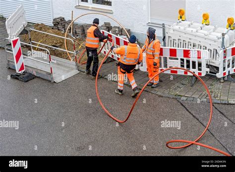 Construction Workers Laying Fibre Optic Cable Cable Trench