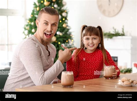 Happy daughter and father with cups of hot cocoa at home Stock Photo ...