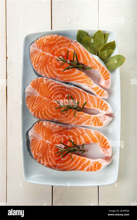 Fresh An Raw Salmon Fillets Uncooked On The Table Of The Kitchen Ready