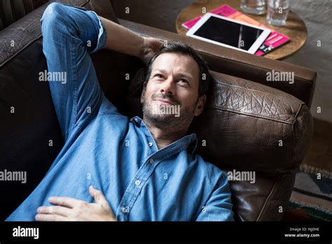 Man Lying On Couch Daydreaming Stock Photo Alamy