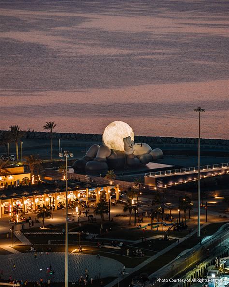 Kaws Companion Lifts Glowing Moon Along Abu Dhabis Waterfront