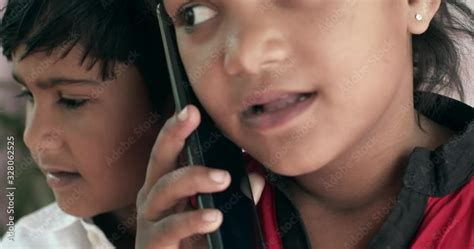 Friends Like Siblings Using A Smart Phone Mobile Device To Talk And