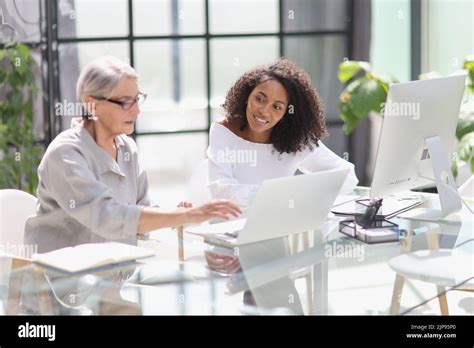 Software Development Team Discussing Algorithms On Computer Screen In