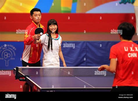 Chinese Table Tennis Player Zhang Jike Back Instructs A Fan To Play Table Tennis At A