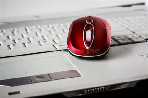 A Beautiful Red Wireless Mouse On The White Keyboard Of A Laptop Stock Photo Image Of Light