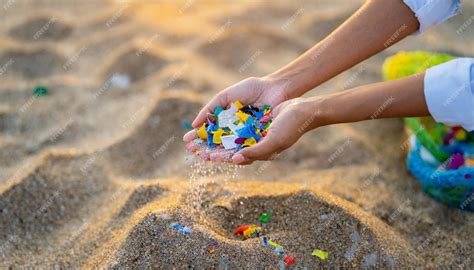 Premium Photo Collecting Microplastics From Sandy Beach Symbolizing