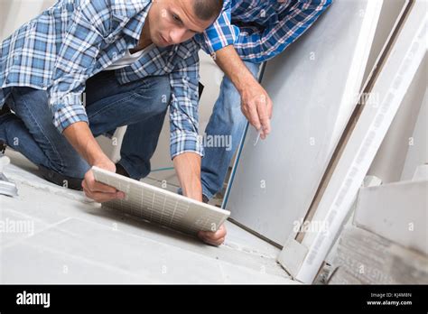 Setting A Tile Stock Photo Alamy
