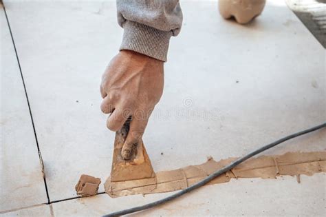 Mason Passing The Paste In The Joint Between Tiles I Work In A