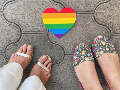 Premium Photo Low Section Of Lesbian Couple Standing By Heart Shape