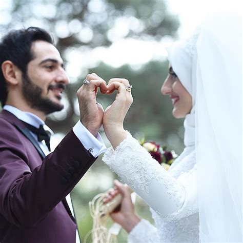 The Bride And Groom Are Holding Hands Together
