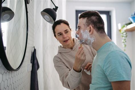 Mother Applying Shaving Foam On Sonand X27s Face Young Man With Down