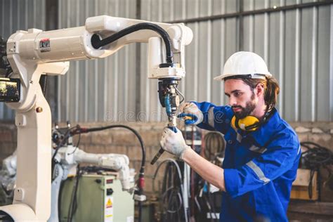 Engineers Mechanic Using Computer Controller Robotic Arm For Welding