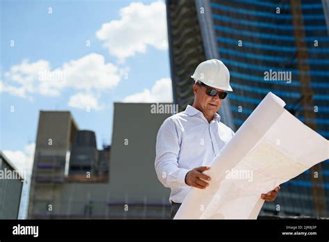 This Project Is Taking Flight A Professional Male Architect Standing On A Building Site While