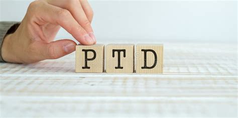 A Hand Is Touching A Wooden Block With The Letters Ptd On It Stock Image Image Of Block