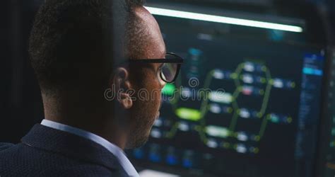 African American Software Engineer Looks At Computer Screen Stock Image
