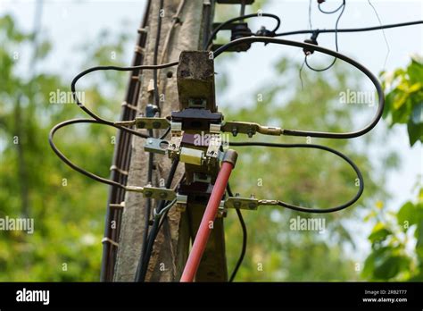Electrician Using A Clamp Stick To Repair The Low Voltage Fuse Switch On Electric Power Pole