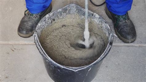 Construction Worker Pouring Self Leveling Concrete On The Floor Stock