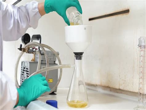 A Science Researcher Doing Filtration For Extraction Of Compound Stock
