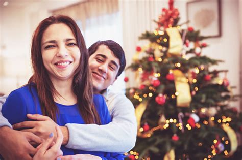 Playful Mother And Son Teasing Each Other And Facing Camera For A