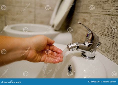 Warm Water Pours Into Small Bathtub With Fountain For Washing Genitalia